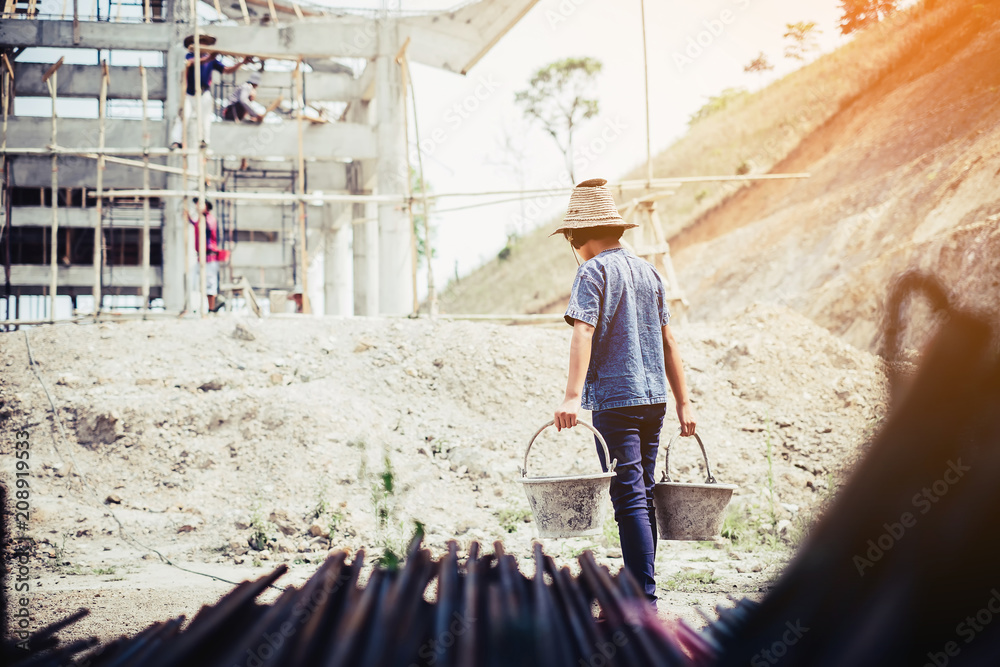 Little girl labor working in commercial building structure, World Day ...
