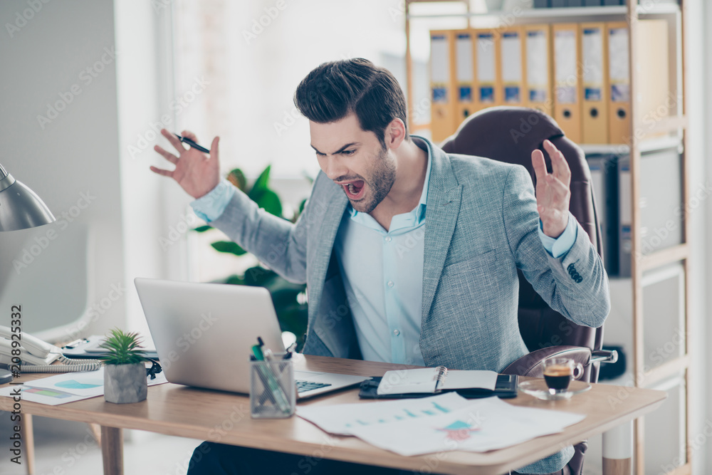 Portrait of rage boss is out of himself, gesturing with hand, yelling ...