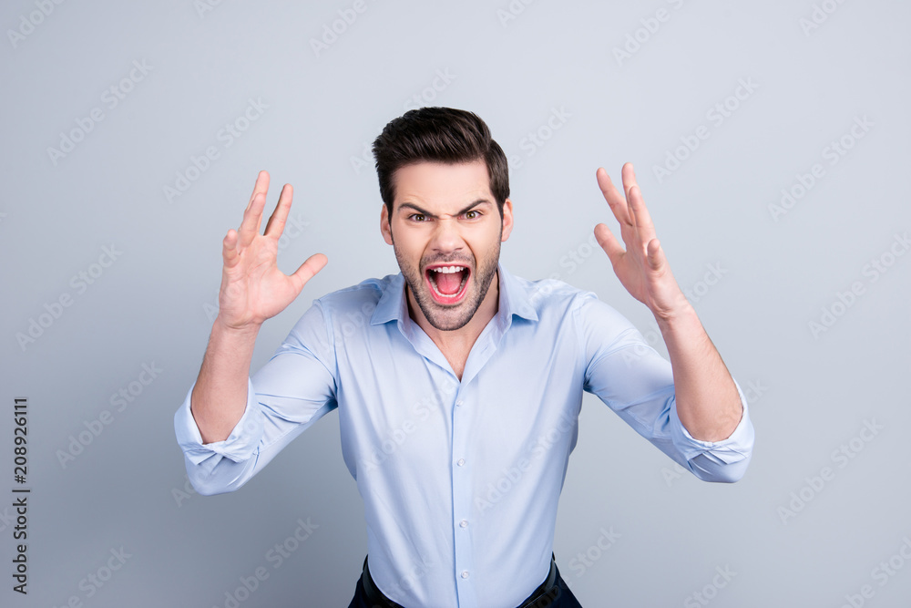 Portrait of very angry annoyed man out of himself, shouting, yelling ...