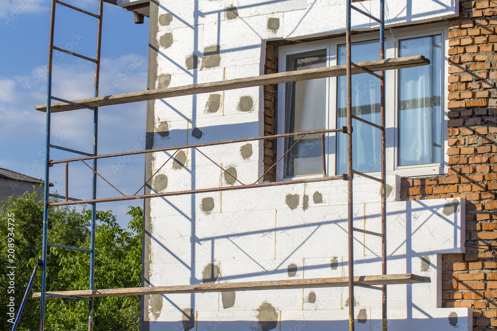 Scaffold on house, renovation. House for renovation with the ...