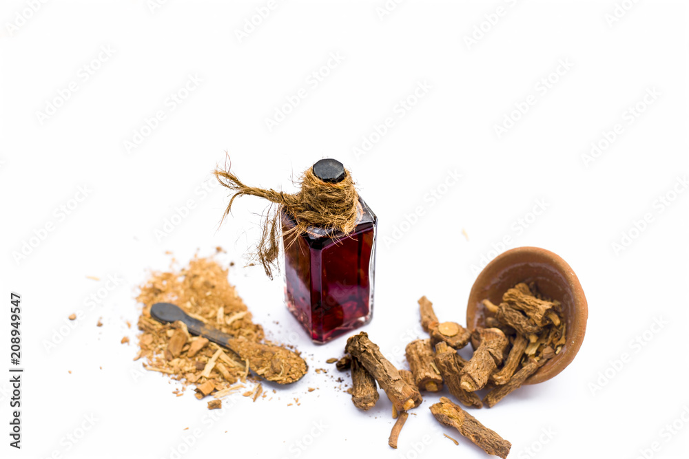 Dark red colored essence of nannari or Indian sarsaparilla in a ...