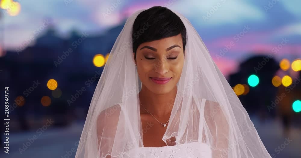 Happy blushing bride outside at night smiling at camera beautiful and ...