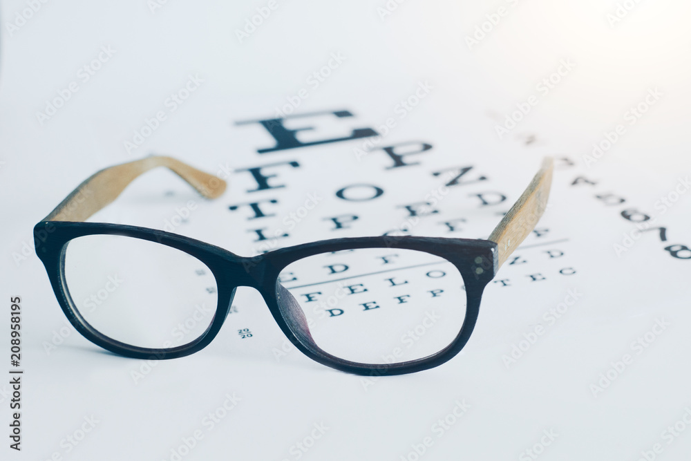 Photo & Art Print Eyeglasses on an optician visual text chart with ...