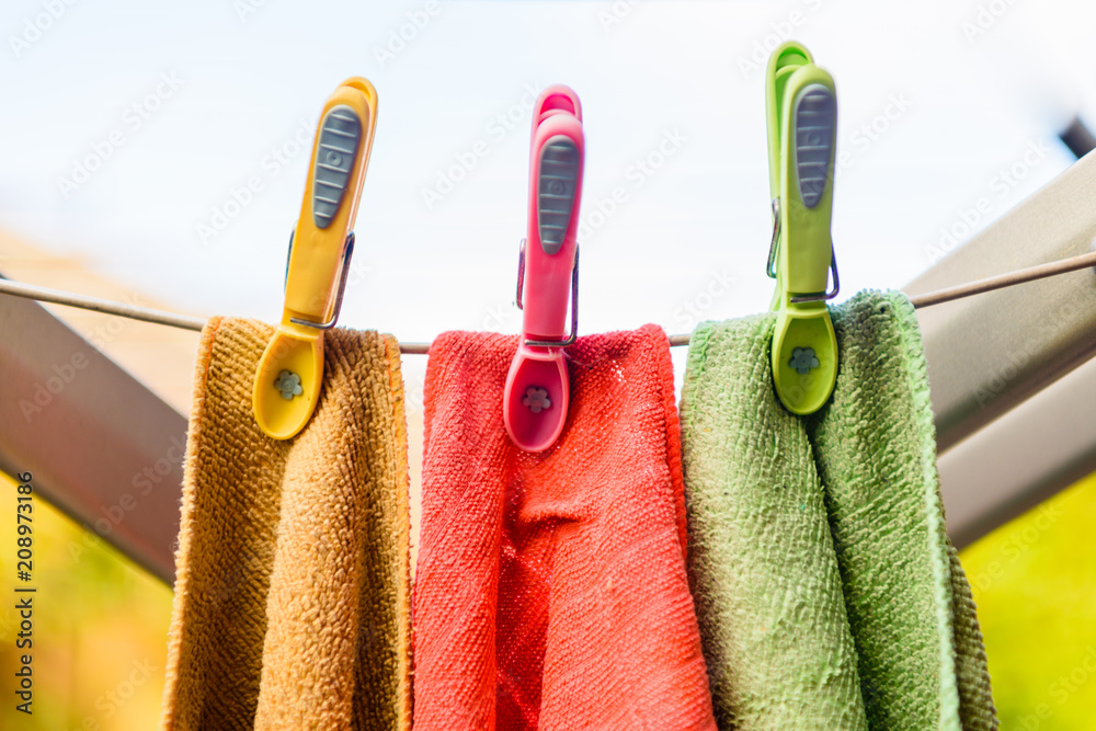 Clothes hanging out on a clothes line to dry with plastic clothes pegs ...