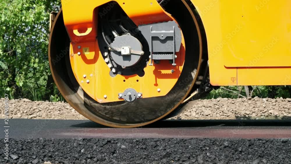close-up, Road construction works with roller compactor machine and ... close-up, Road construction works with roller compactor machine and ...