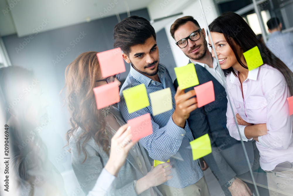 Business people meeting at office and use post it notes to share idea ...