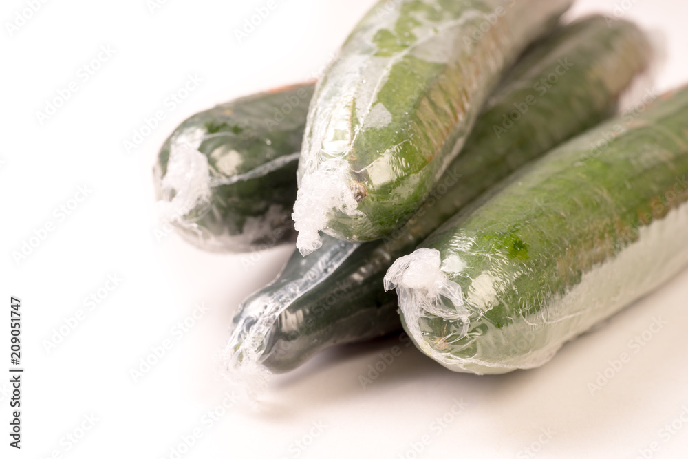 Bunch of cucumber wrapped in plastic films Stock Photo | Adobe Stock