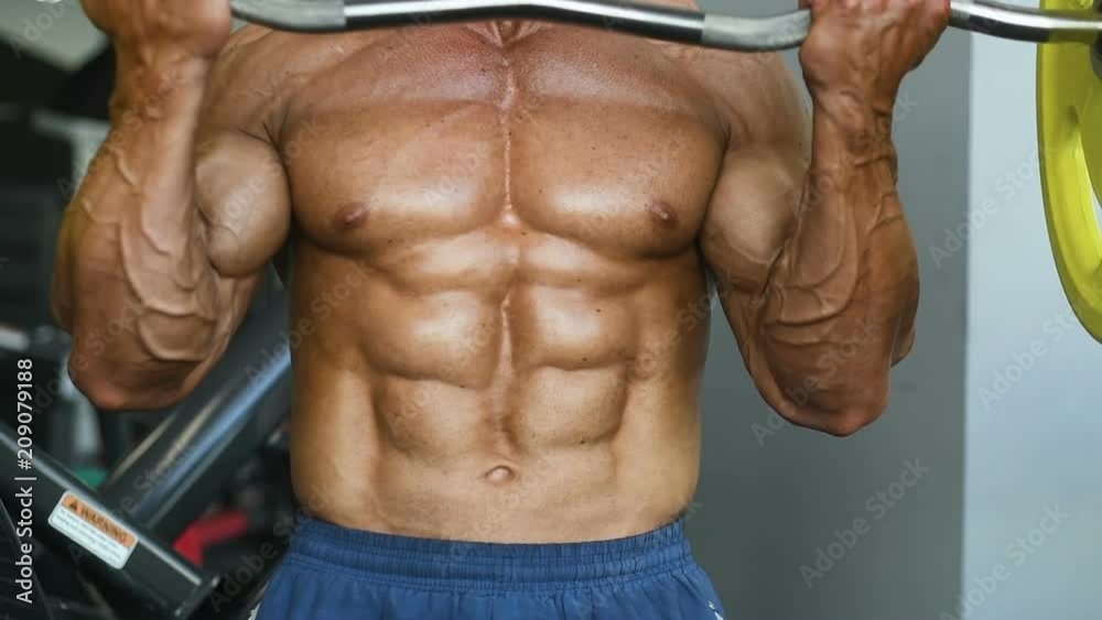 Video Stock slow motion Brutal strong bodybuilder athletic man pumping up muscles workout ...