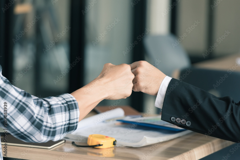 Businessman or partners business people giving fist bump after complete ...
