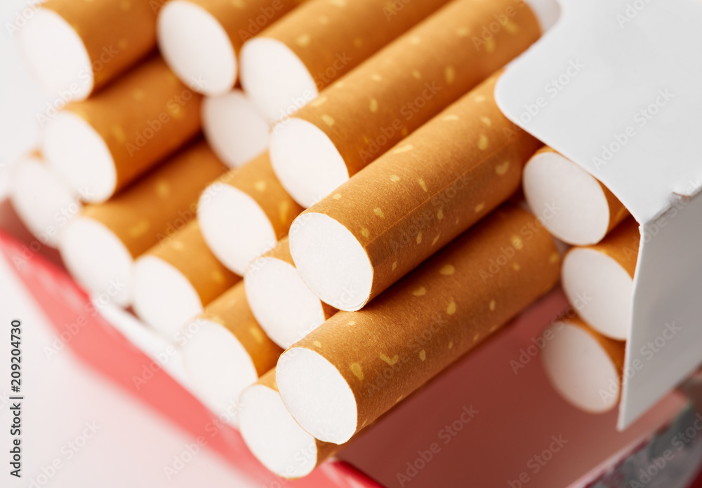 cigarettes in a pack close-up on a white background. Drug addiction ...