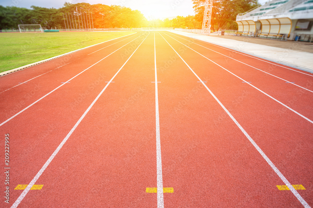 White lines of stadium and texture of running racetrack red rubber ...