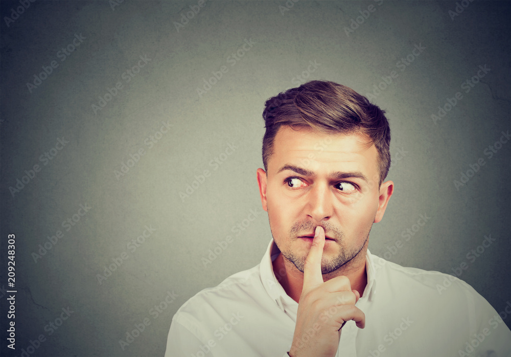 Scared man with finger on lips Stock-Foto | Adobe Stock