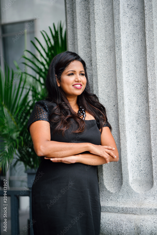 An image of a successful and attractive Indian Asian woman leaning on a ...