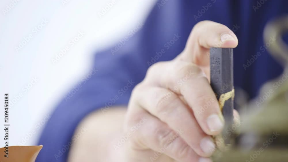 Refocus from snake and turtle statue to ink preparation 4K. Dolly slide ...