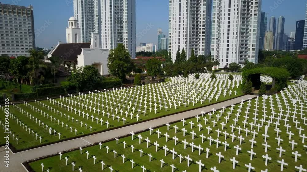 Slow aerial view of serene cemetery for fallen Dutch citizens and ...