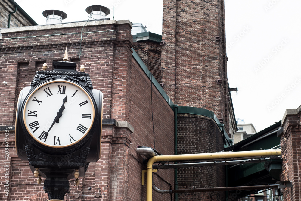 Analog Clock with brick buildings in the background Stock Photo | Adobe ...
