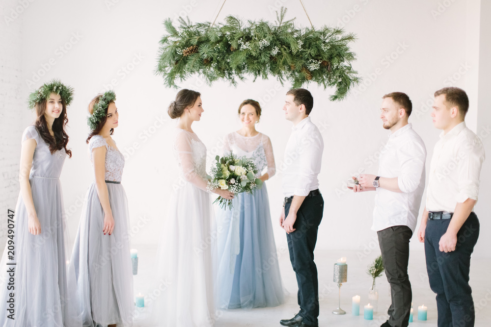 Bride and groom during wedding ceremony indoors. Ceremony master ...