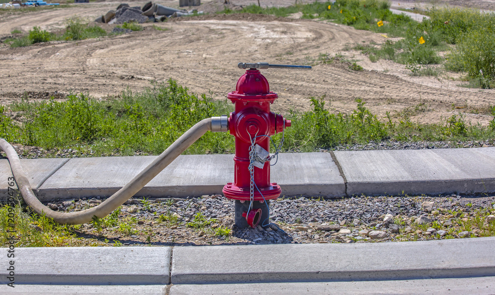 Fire hose and wrench connected to hydrant Stock Photo | Adobe Stock