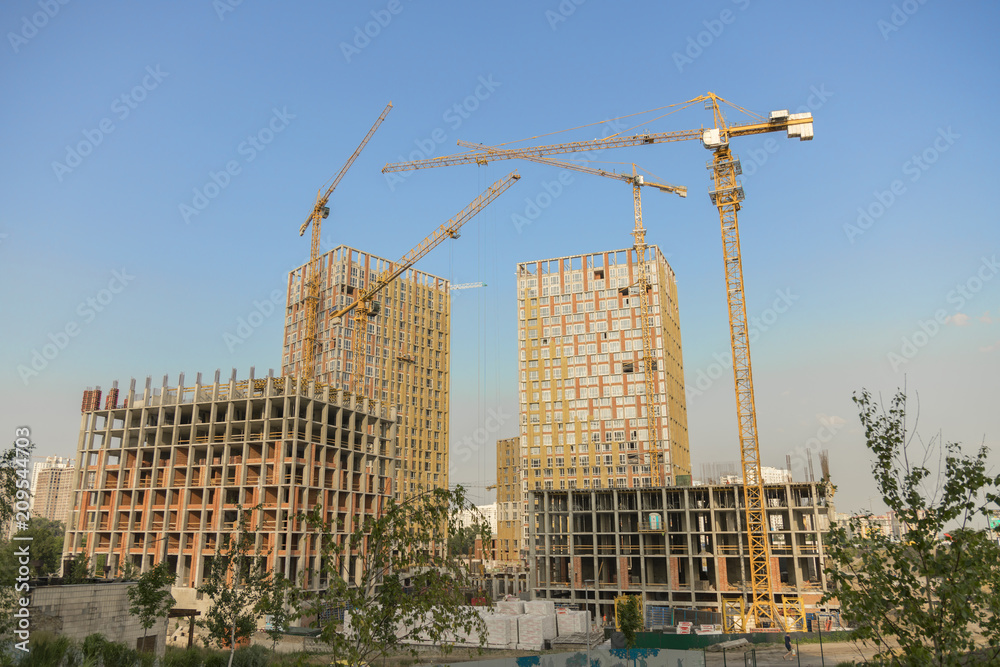 Hoisting crane and new multi-storey building. ndustrial background ...