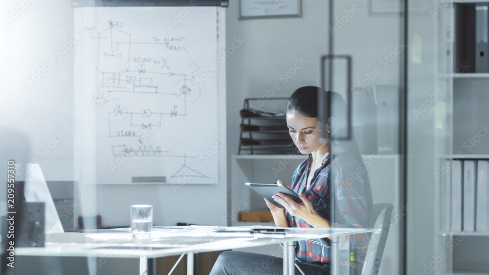 Female Design Engineer Sits at the Glass Table in Her Office, Works on ...