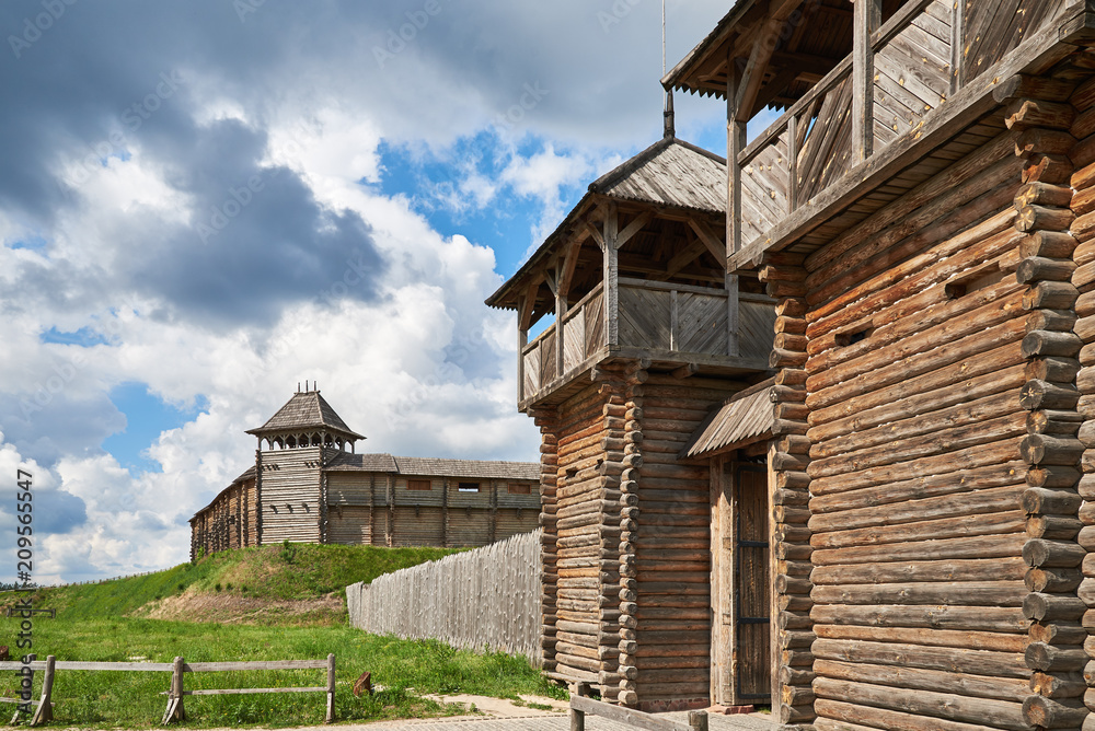 Fragment of a wooden fortress with gate, towers, a wall and a palisade ...