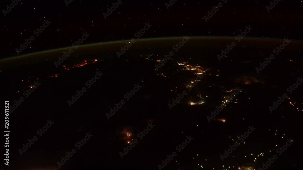 Intense flashes of lightning can be seen above a city at night in this ...