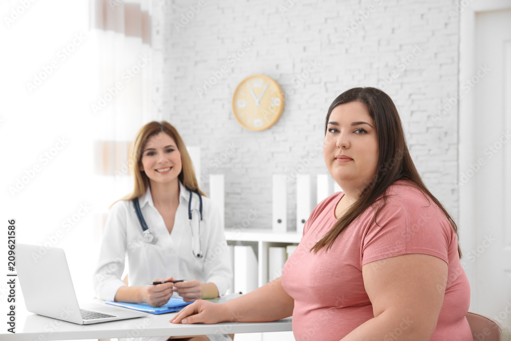 Female doctor and overweight woman in clinic Stock Photo | Adobe Stock