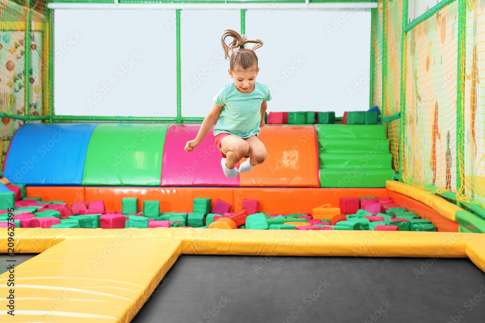 Cute girl jumping on trampoline in entertainment center Stock Photo ...