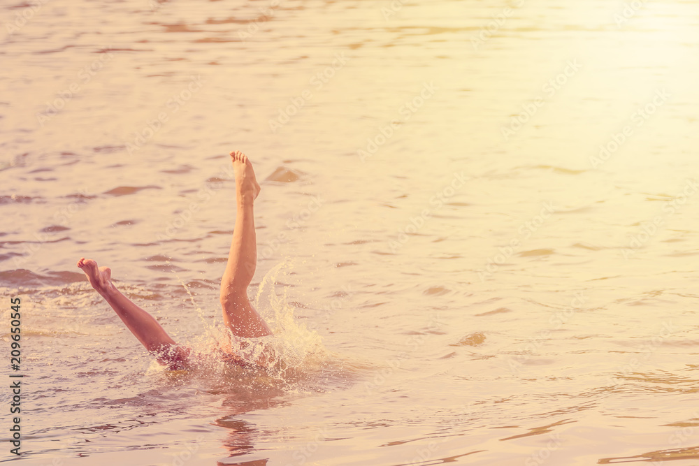 Girl falling jumping into the water with splash. Recreation concept ...