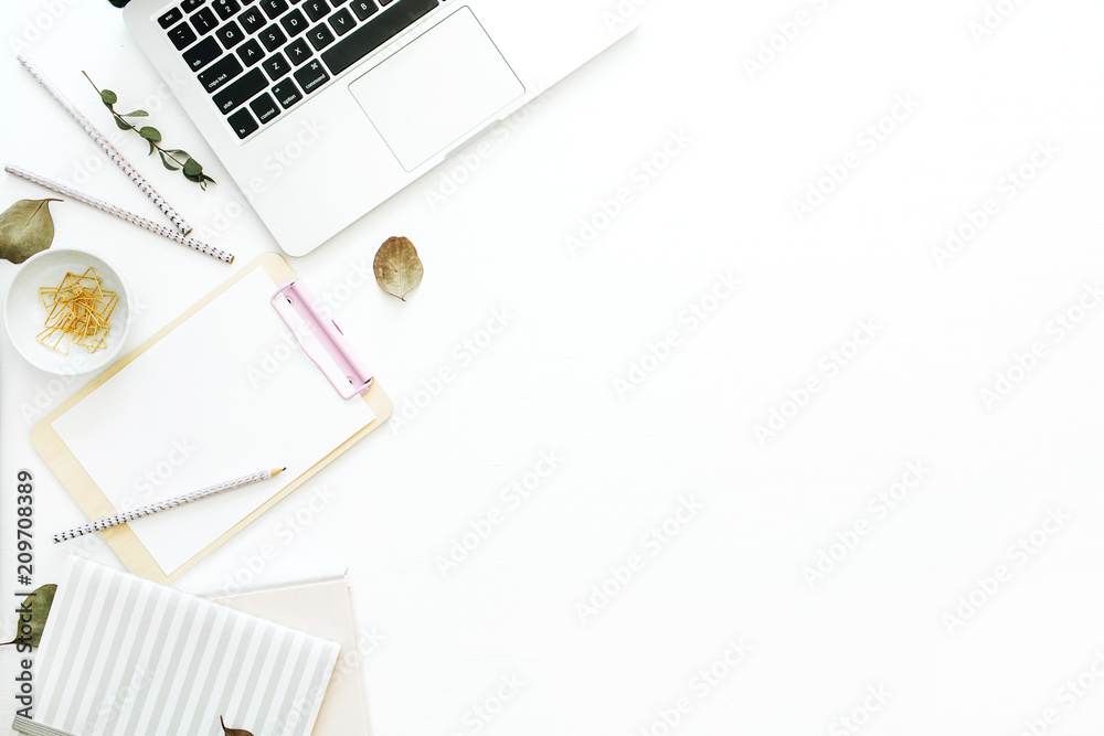 Flat lay home office desk workspace with laptop, notebook and clipboard ...