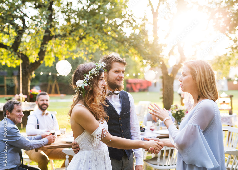 Young girl congratulating bride and groom at wedding reception in the ...
