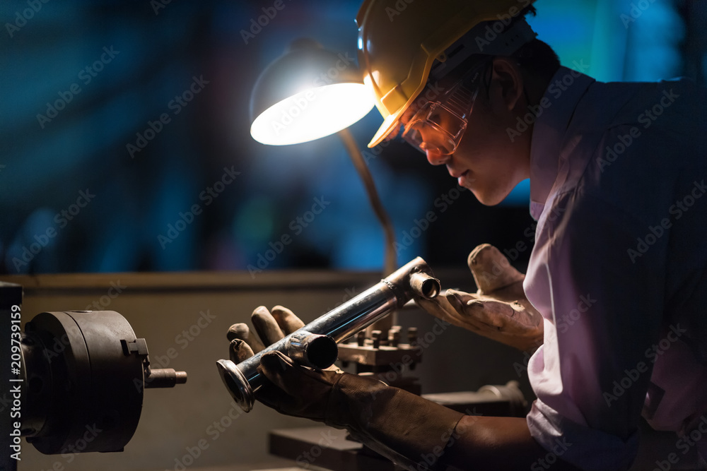 Mechanic Engineer Turner Miller verifies the accuracy of manufacturing ...