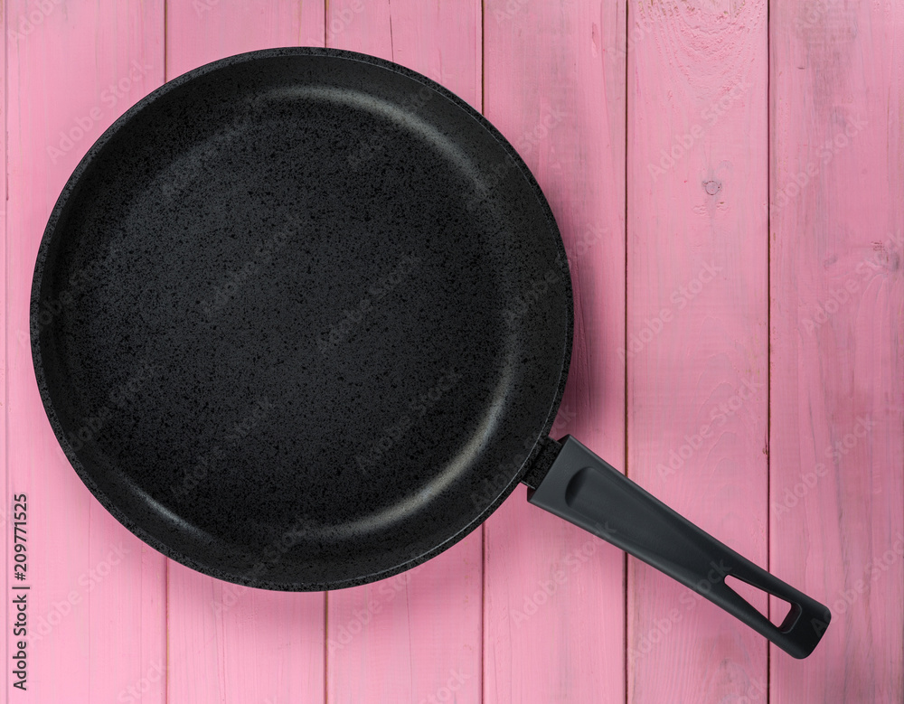 Cast-iron frying pan with non-stick coating against a background of ...