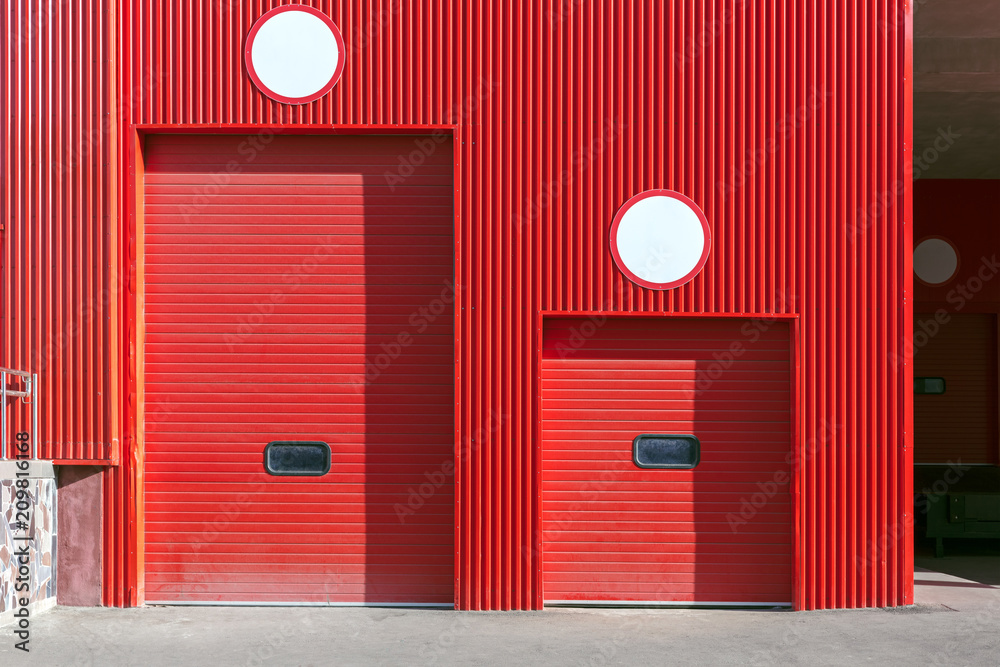 roller shutter gate of different size on red wall of distribution ...