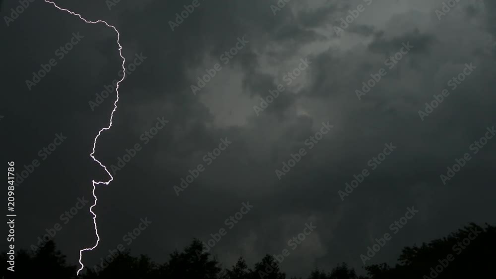 Storm and shower with lightning. Heavy rain with black clouds and wind ...