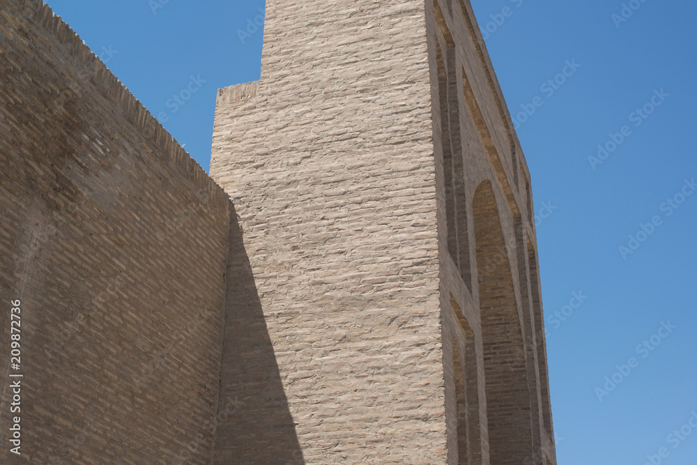 An old brick building with a tower. Ancient buildings of medieval Asia ...