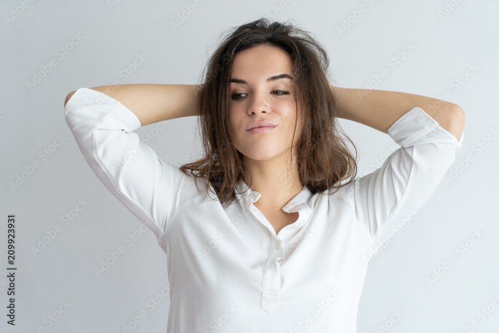 Arrogant rebel girl setting hair and smirking. Shaggy young Caucasian ...