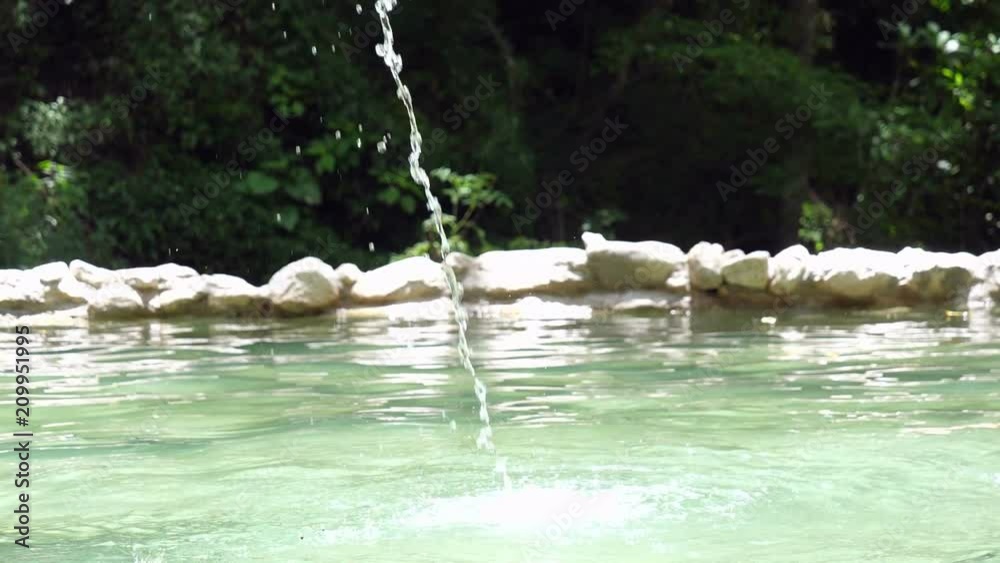 Slow motion splasing water jet in a hot springs in the Caribbean. Slow ...