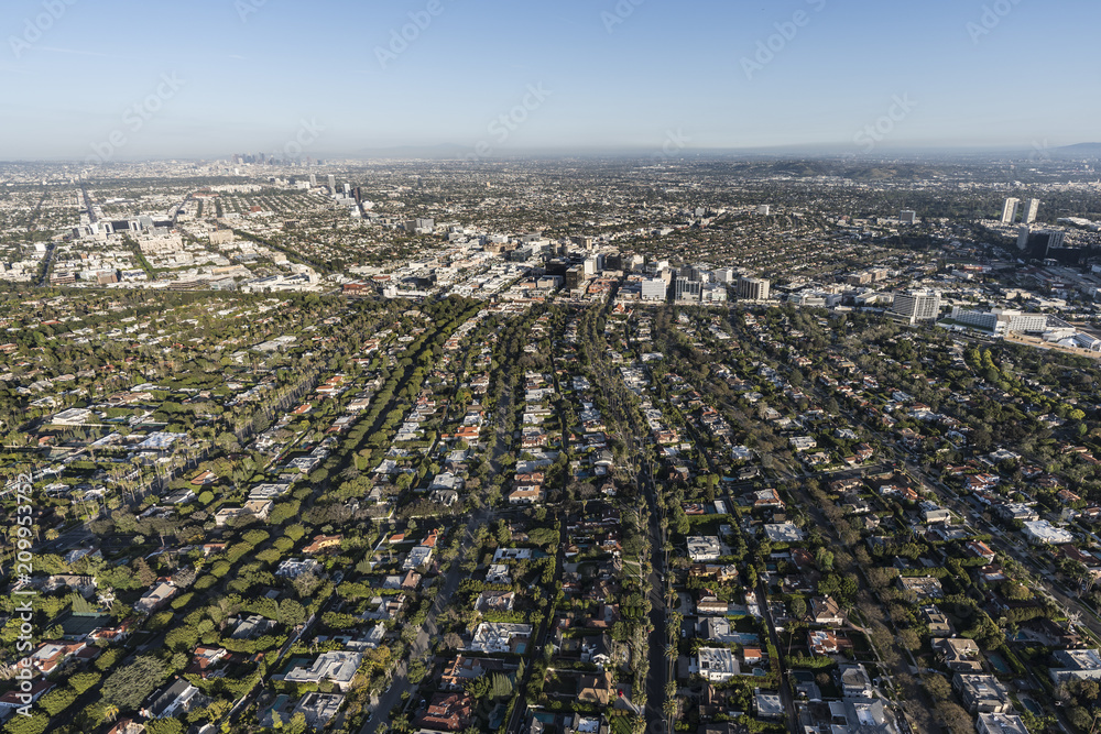 Afternoon aerial view of Beverly Hills streets with mid Wilshire and ...
