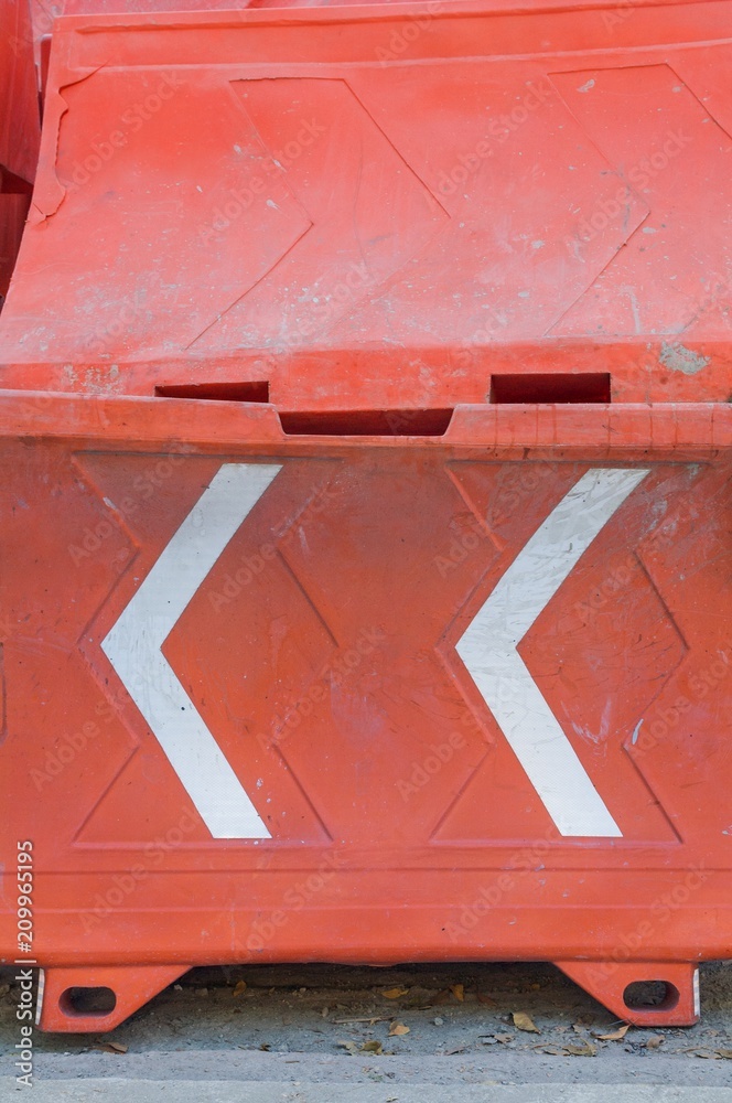 Plastic barrier in orange color used as a safety signal during ...