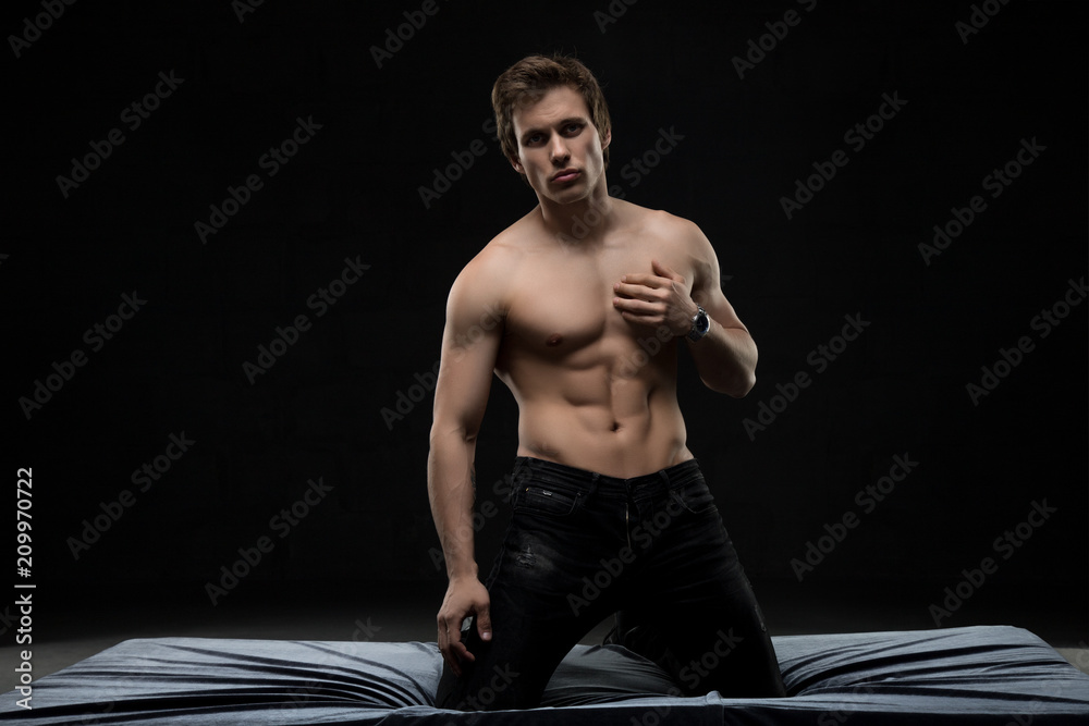 Shirtless muscular man staying on his knees shot Stock Photo | Adobe Stock