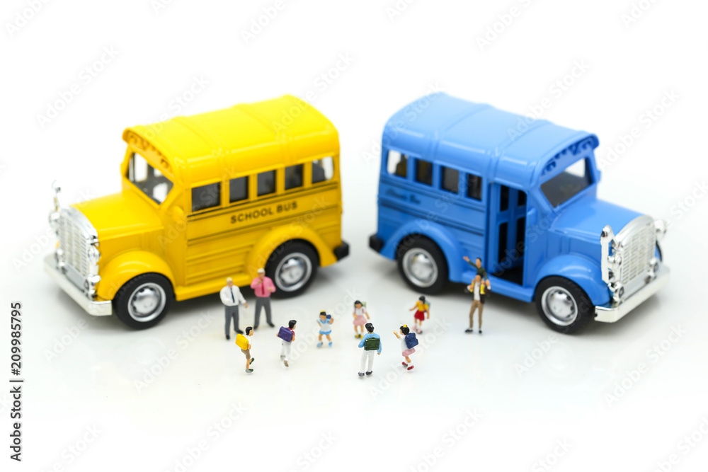 Miniature people : A group of young children getting on the schoolbus ...