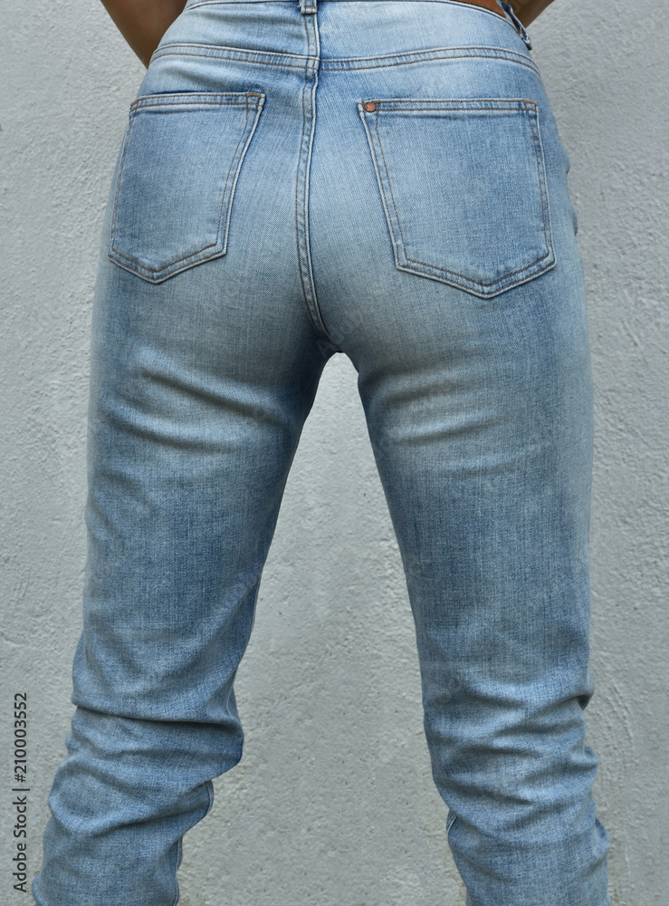 Young stylish woman wearing of jean pants from back. Female bottom in ...