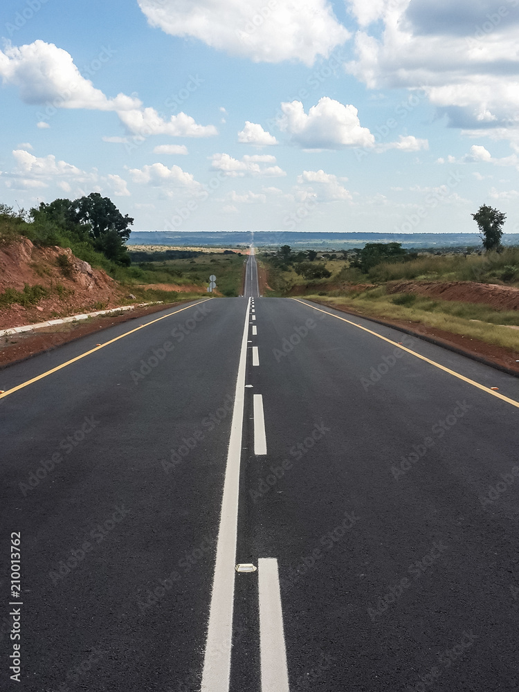 Long straight asphalt road with diminishing perspective in countryside ...