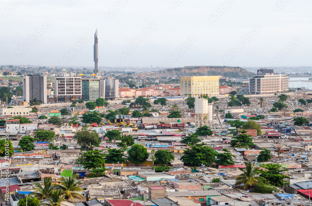 High angle view over slums of Luanda with Mausoleum of Agostinho Neto ...