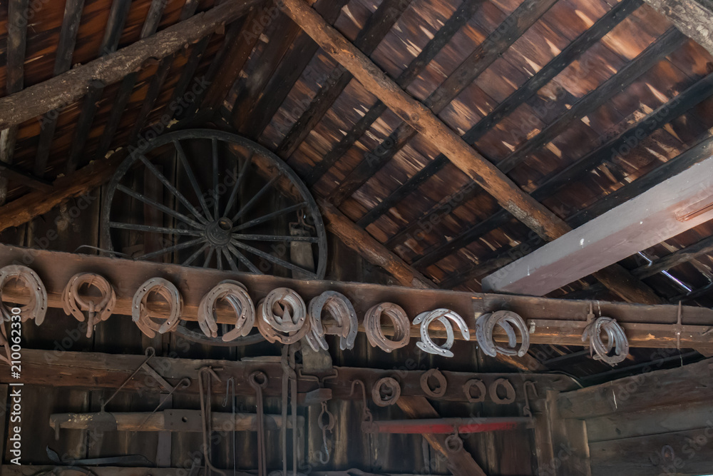 Barn loft with horseshoes and tools on rafters Stock Photo | Adobe Stock
