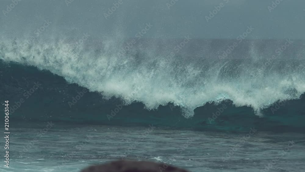 SLOW MOTION, CLOSE UP: Massive glassy ocean wave splashing towards a ...