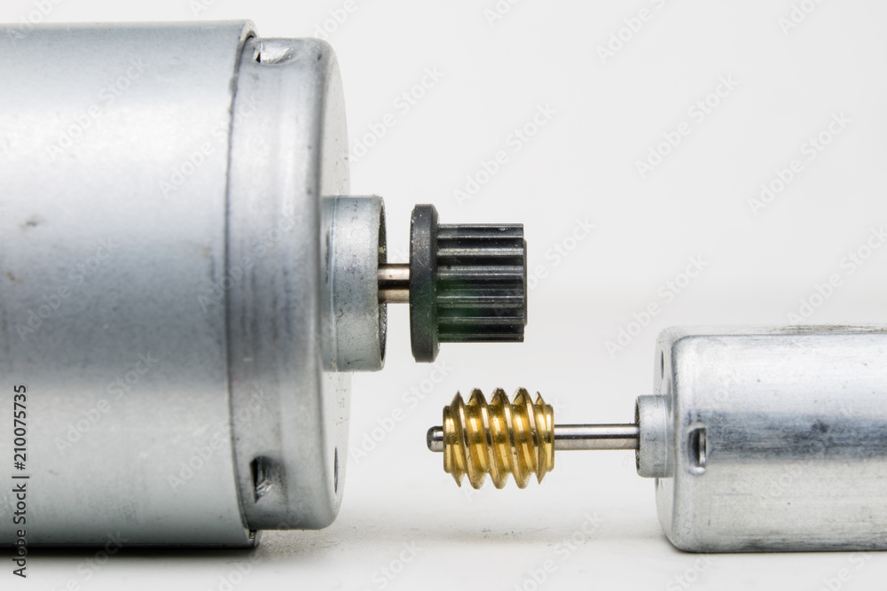 Small electric motor on a white workshop table. Electric drive used in ...