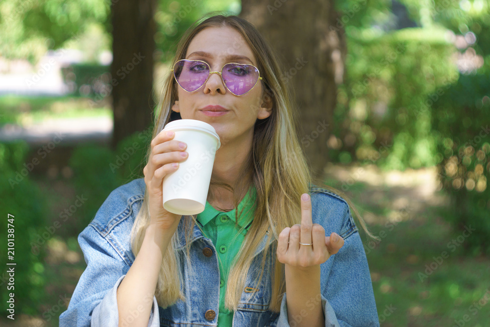 Photo & Art Print Beautiful young girl shows the middle finger, Pavel
