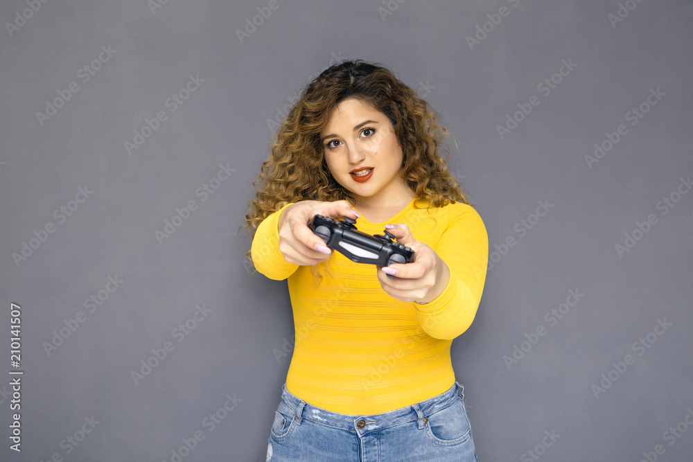 Cute Brunette Plus Size Woman With Curly Hair In Yellow Sweater And